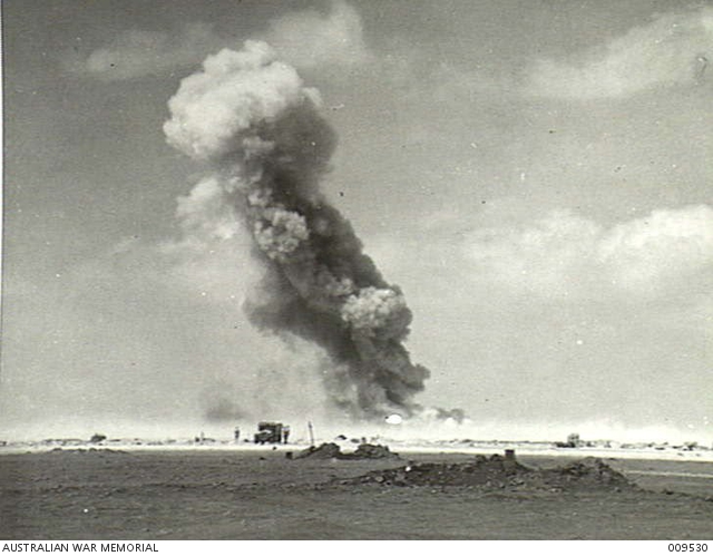 TOBRUK. JERRY'S BOMBS BURSTING IN THE DESERT MAKE A LOT OF DUST BUT ...