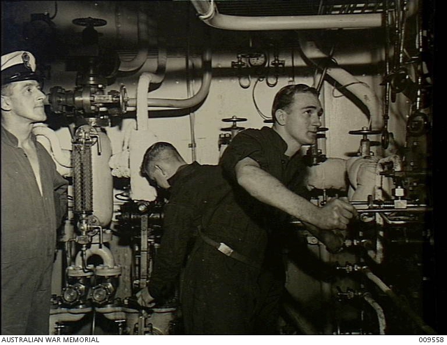 Three members of the engine room staff at work on an Australian built ...