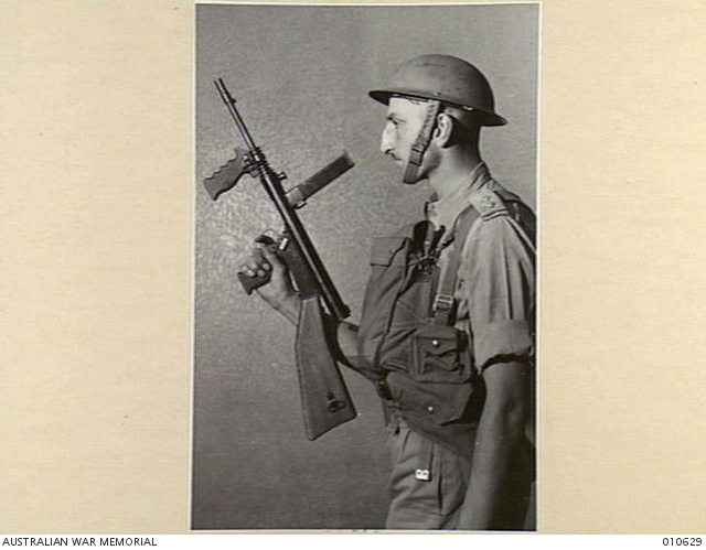 An Australian soldier demonstrating the characteristics of the Owen sub ...