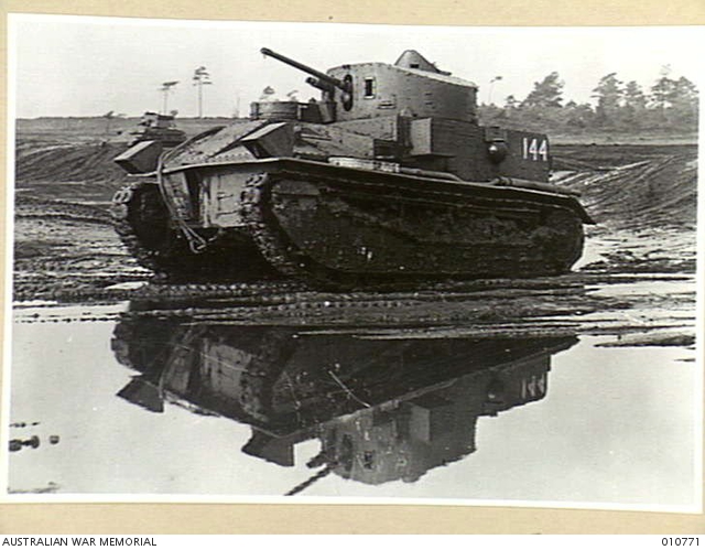 CLOSE UP OF TANK WITH REFLECTION IN WATER. | Australian War Memorial