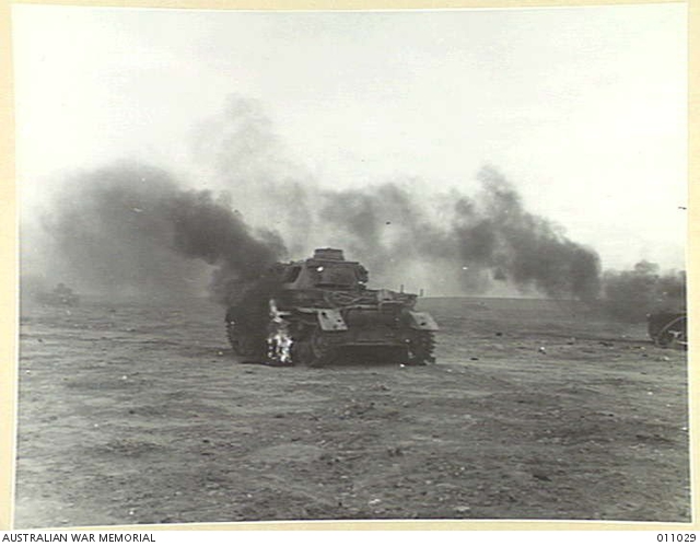 SMOKE RISES FROM ENEMY TANKS AS THE GERMAN FIELD WORKSHOP IS DESTROYED ...