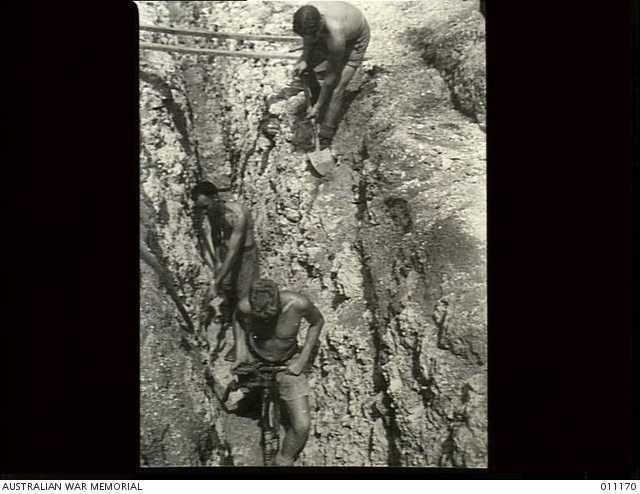 Darwin. Australian soldiers digging and constructing a drain through ...