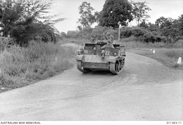 An Australian Army Bren Gun carrier moving up along a rural road for ...