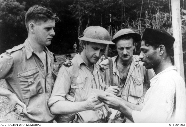 MALAYA. AUSTRALIAN TROOPS GAINING SOME LOCAL KNOWLEDGE FROM A MALAYAN ...