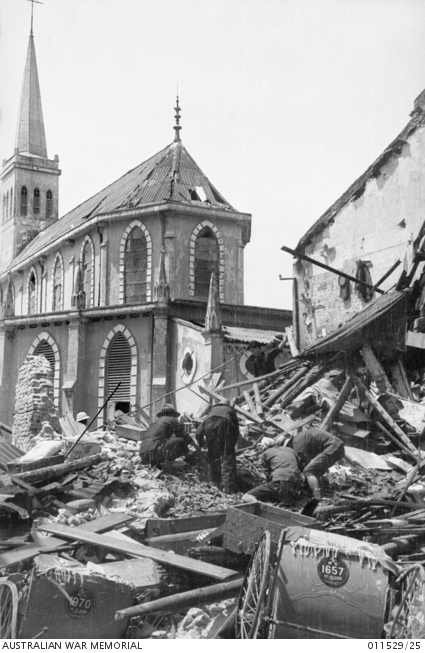 SINGAPORE. CIVILIANS SEARCHING THROUGH DEBRIS AND RUBBLE OF DAMAGED ...