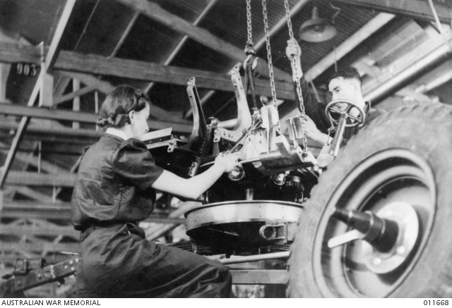 GENERAL MOTORS FACTORY. GIRLS (WOMEN) ASSIST MEN IN THE MANUFACTURE OF ...