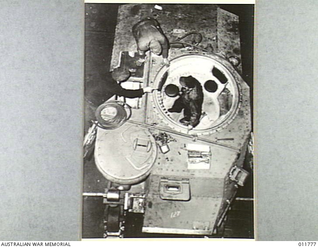 WORKERS ASSEMBLE TANK TURRET. IN THIS OVERHEAD VIEW OF THE ASSEMBLY OF ...