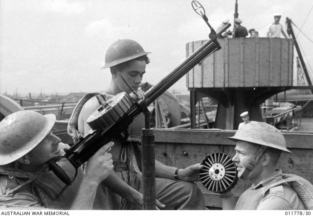 A gun crew manning the Vickers machine gun of the ship carrying some ...