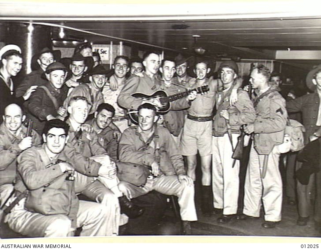 PICTURE SHOWS AMERICAN AND AUSTRALIAN TROOPS SINGING A NEW WAR SONG ...