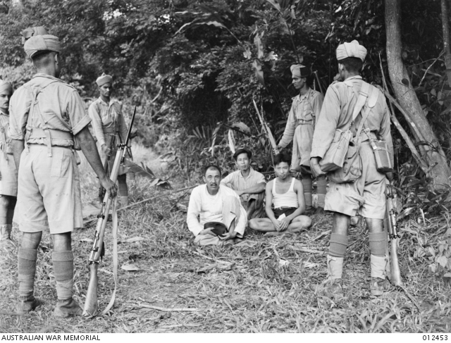 MALAYA. INDIAN TROOPS GUARDING NATIVE SUSPECTS. (NEGATIVE BY BOTTOMLEY ...