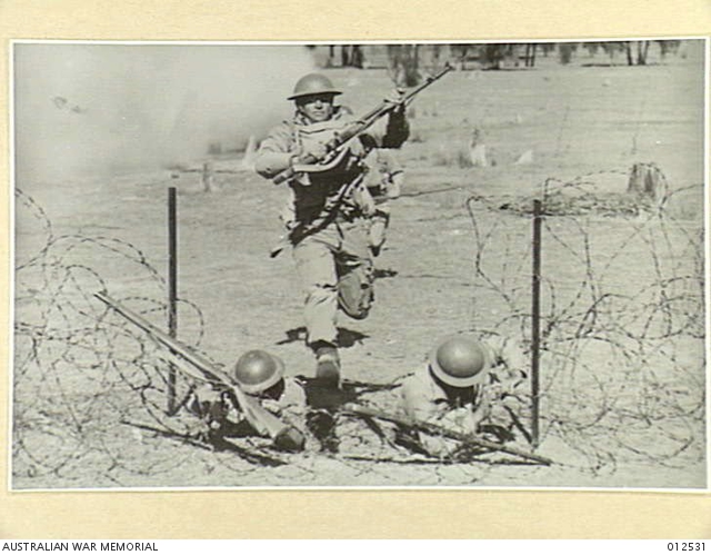 Having crushed the wire, the two men hold it down, allowing the rest of ...