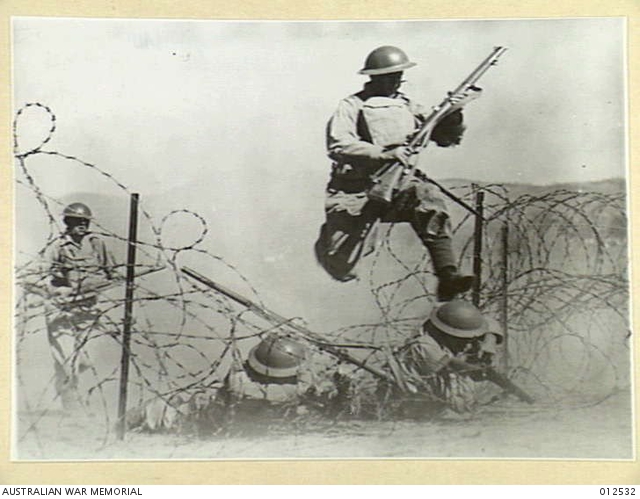 HAVING CRUSHED THE WIRE, THE TWO MEN HOLD IT DOWN, ALLOWING THE REST OF ...