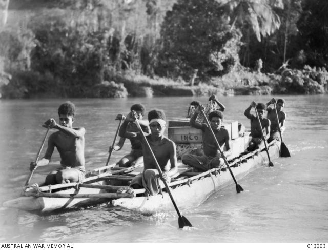 NATIVES MAKING THEIR WAY UPSTREAM IN AN OUTRIGGER WITH ARMY SUPPLIES ...