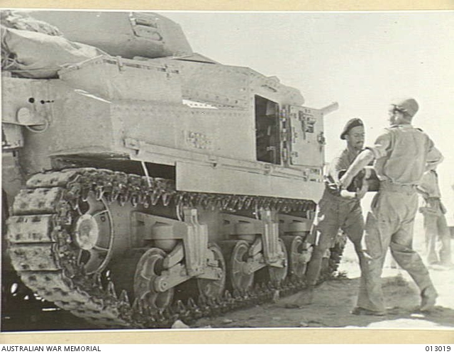 HERE A GENERAL GRANT M3 MEDIUM TANK IS BEING LOADED WITH AMMUNITION, ON ...