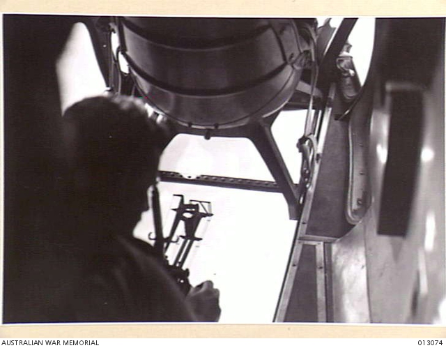 THE BOMB AIMER MAKES READY FOR A "RUN IN" DURING AN ALLIED RAID AGAINST ...