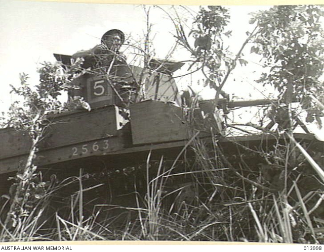 PAPUA. CAMOUFLAGED AUSTRALIAN TANK AWAITING THE SIGNAL TO MOVE FORWARD ...