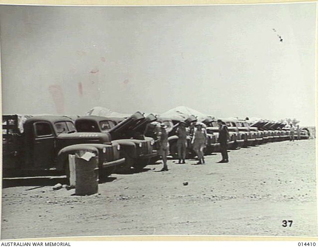 NORTH SOUTH MILITARY HIGHWAY. IMMEDIATELY A CONVOY PULLS INTO A STAGING ...