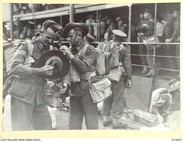 SOLDIERS DISEMBARKING FROM A TROOP TRANSPORT SHIP ON THEIR RETURN HOME ...