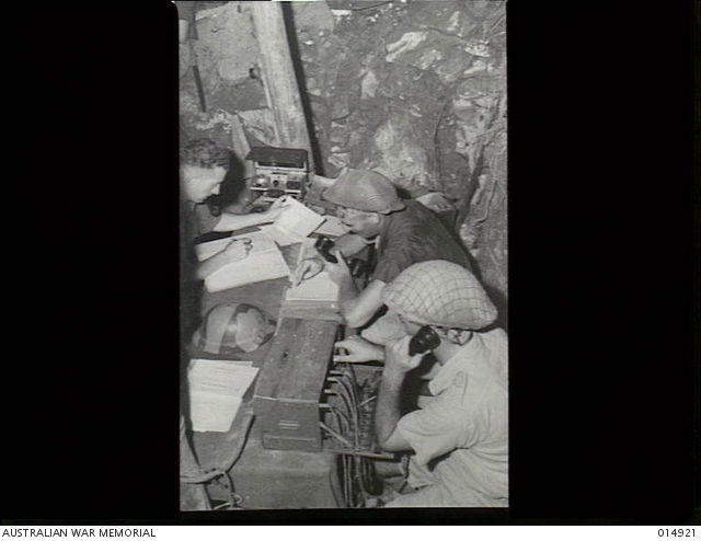 Australian Army signallers at work underground with telephony equipment ...