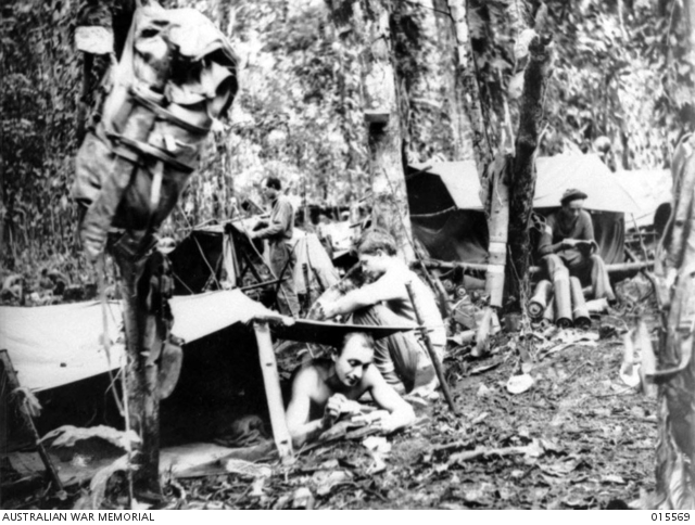 NEW GUINEA. MOUNT TAMBU. LIVING QUARTERS MADE OF GROUND SHEETS ...