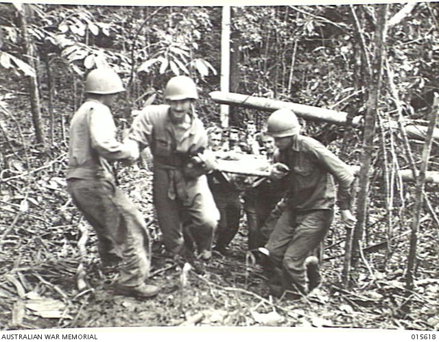 NEW GUINEA. AN AMERICAN BEING CARRIED UP A ONE IN THREE TRACK ON MOUNT ...