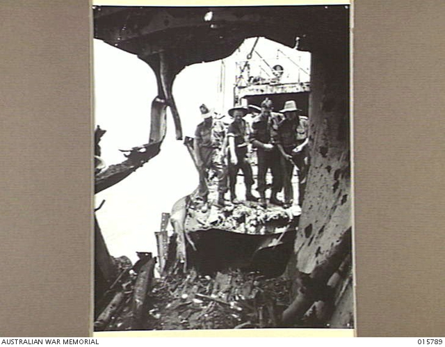 NEW GUINEA. FALL OF LAE. SOLDIERS LOOK INSIDE THE WRECKED JAPANESE SHIP ...