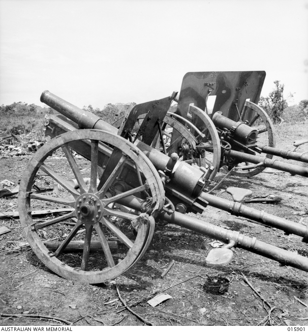 NEW GUINEA. LAE. SMASHED JAPANESE FIELD GUNS AMONGST THE WRECKAGE, OF ...