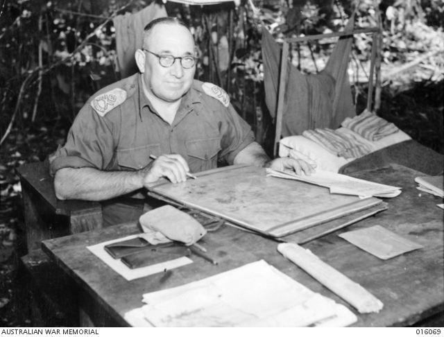Finschhafen, New Guinea. NX7 General George F. Wootten at his desk in a ...