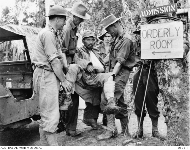 New Guinea. A Japanese prisoner of war (POW) with an arm and leg injury ...