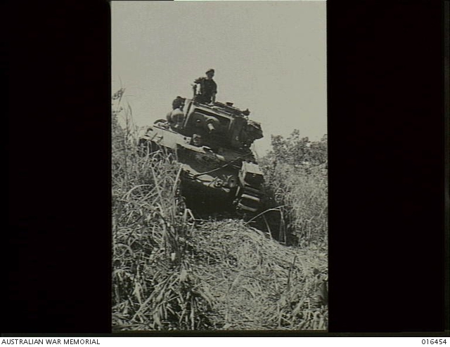 New Guinea. A Matilda tank about to cross a creek bed in the wake of ...