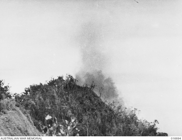 Finisterre Range, New Guinea. Smoke rises after the strafing of ...