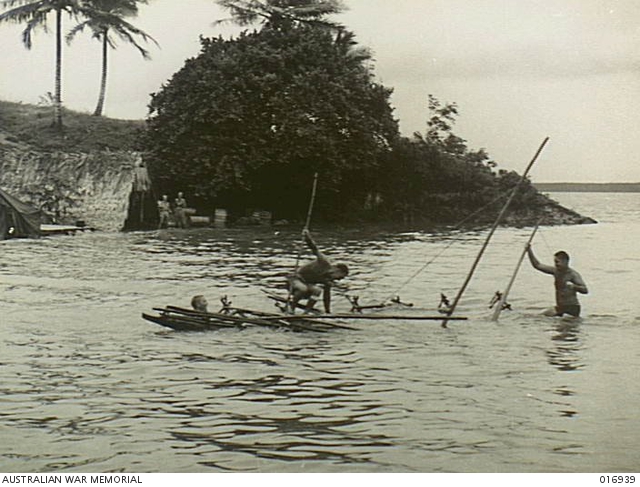 New Guinea. Three members of the Marine Food Supply Unit, on a lakatoi ...