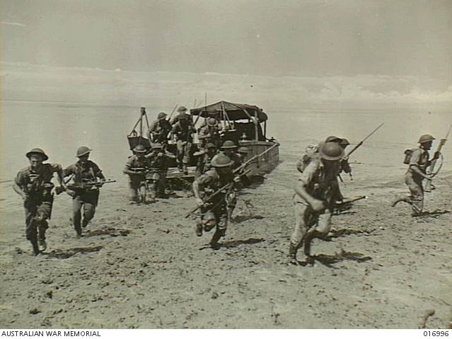 Dutch New Guinea. Troops coming ashore from a landing barge at an up ...
