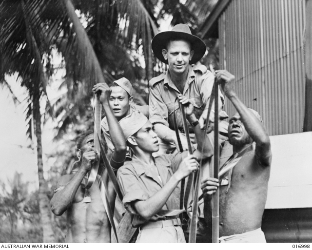 New Guinea. Sergeant Wright Thompson of Gunnedah, NSW, shows a spool of ...