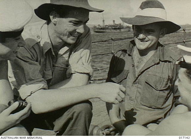 Troops fraternise with the naval personnel after the Navy's successful ...