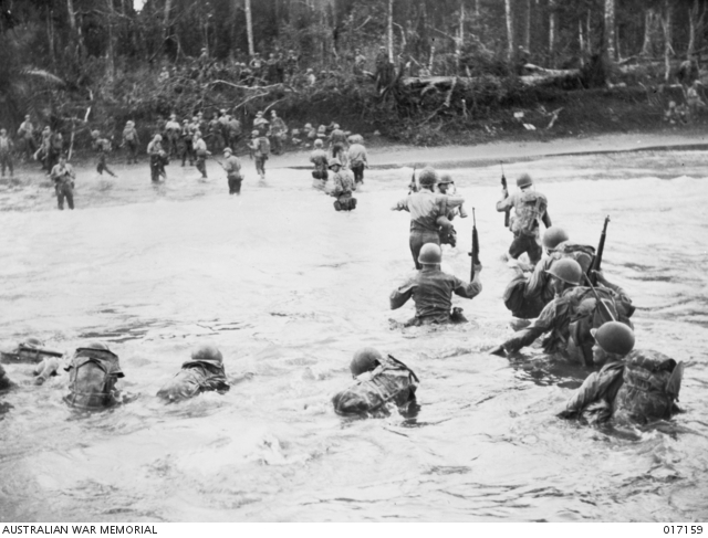 Dutch New Guinea. Americans struggle ashore through the swirling sea ...