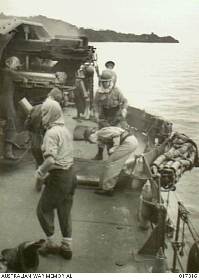 At Sea, New Guinea. Gunners in action on the Australian built tribal ...