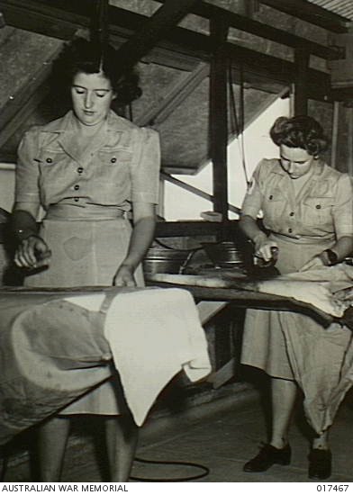 Two members of the Women's Royal Australian Naval Service (WRANS) iron ...