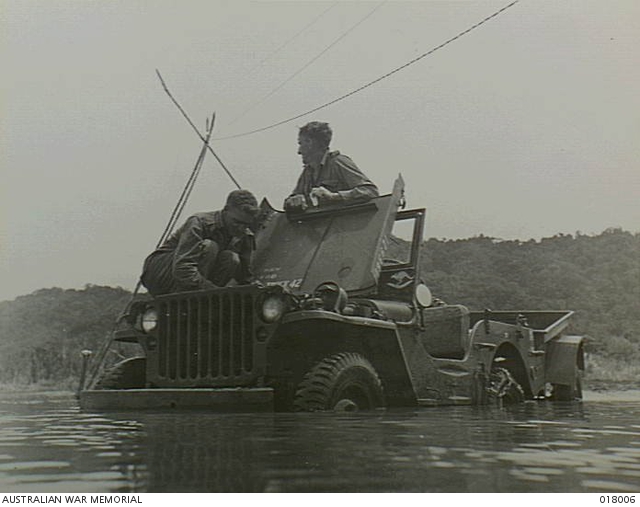 Aitape, New Guinea. These two Aussies make a vain attempt to restart ...