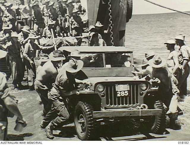Tsimba Area, Bougainville. Australian artillerymen give a hand to beach ...