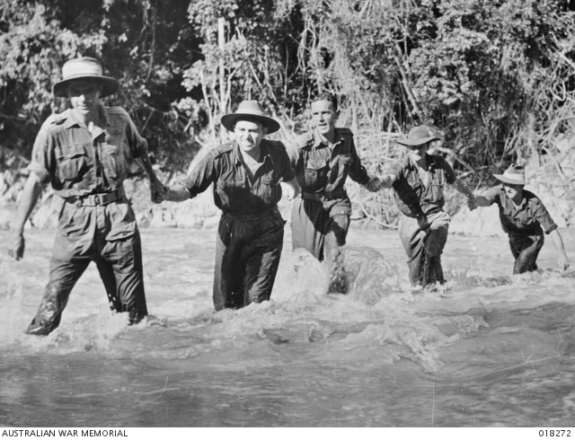 Aitape, New Guinea. War correspondents join hands to ford a raging ...