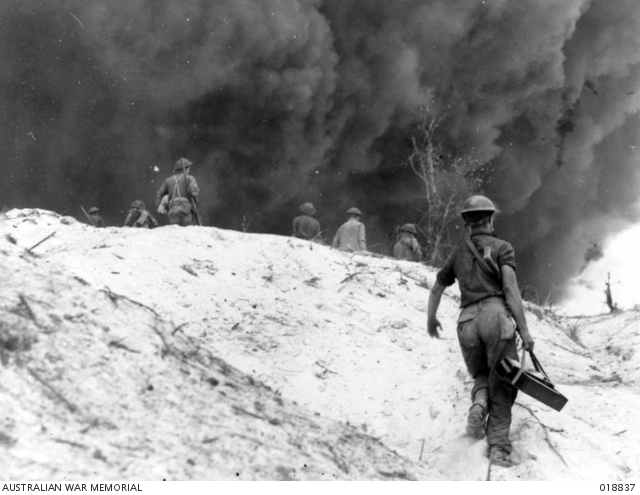 Balikpapan, Borneo. 1945-07. Australian infantry troops advance along a ...