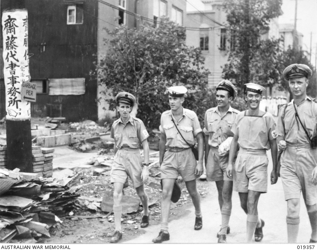 Yokohama, Japan. Men from HMAS Nepal on shore leave in Yokohama passing ...