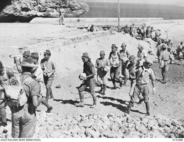 Koepang, Timor. 1945. Japanese working parties repairing wharf and road ...