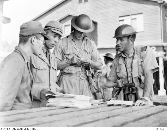 Two Japanese commissaries (left), in the Yokosuka Naval Base surrender ...