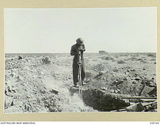 An engineer digging pits for Headquarters, with the aid of a pneumatic ...