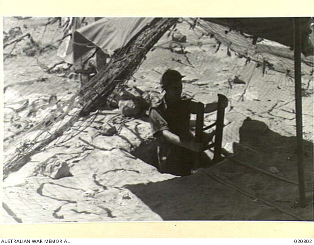 An Australian soldier coming up from the underground orderly room of ...