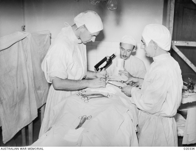 The surgeon (left) preparing to operate on a soldier for a chest injury ...