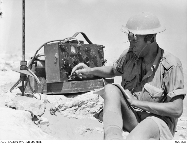 A signaller of 9th Division Signals at work with a field set near ...