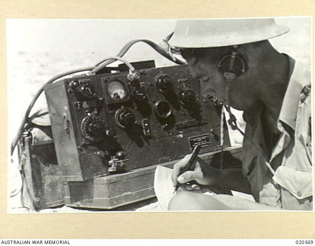 A signaller of 9th Division Signals working with a field wireless ...